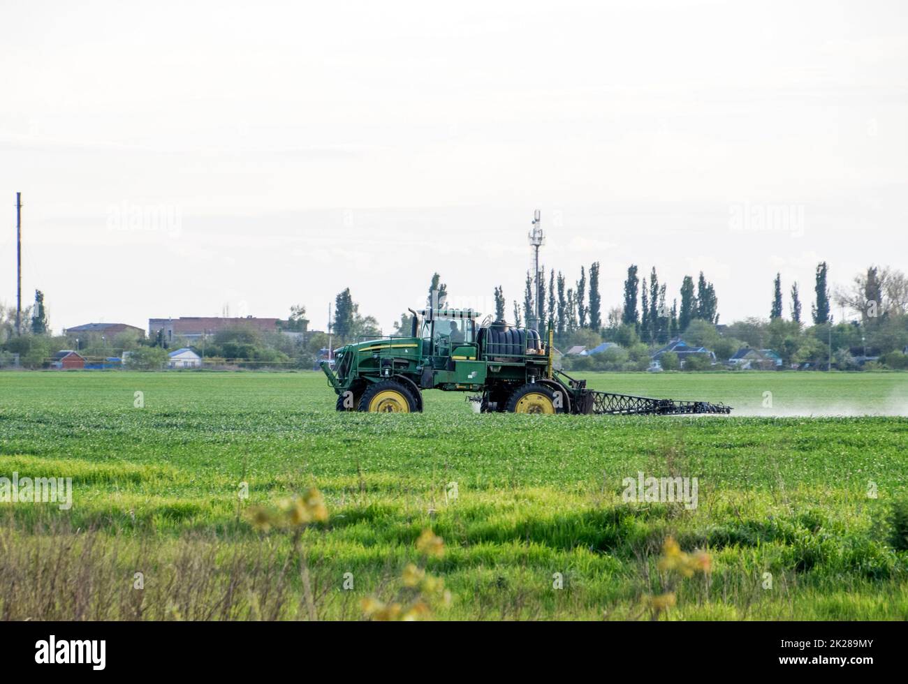 Tractor with a spray device for finely dispersed fertilizer. Tractor on ...