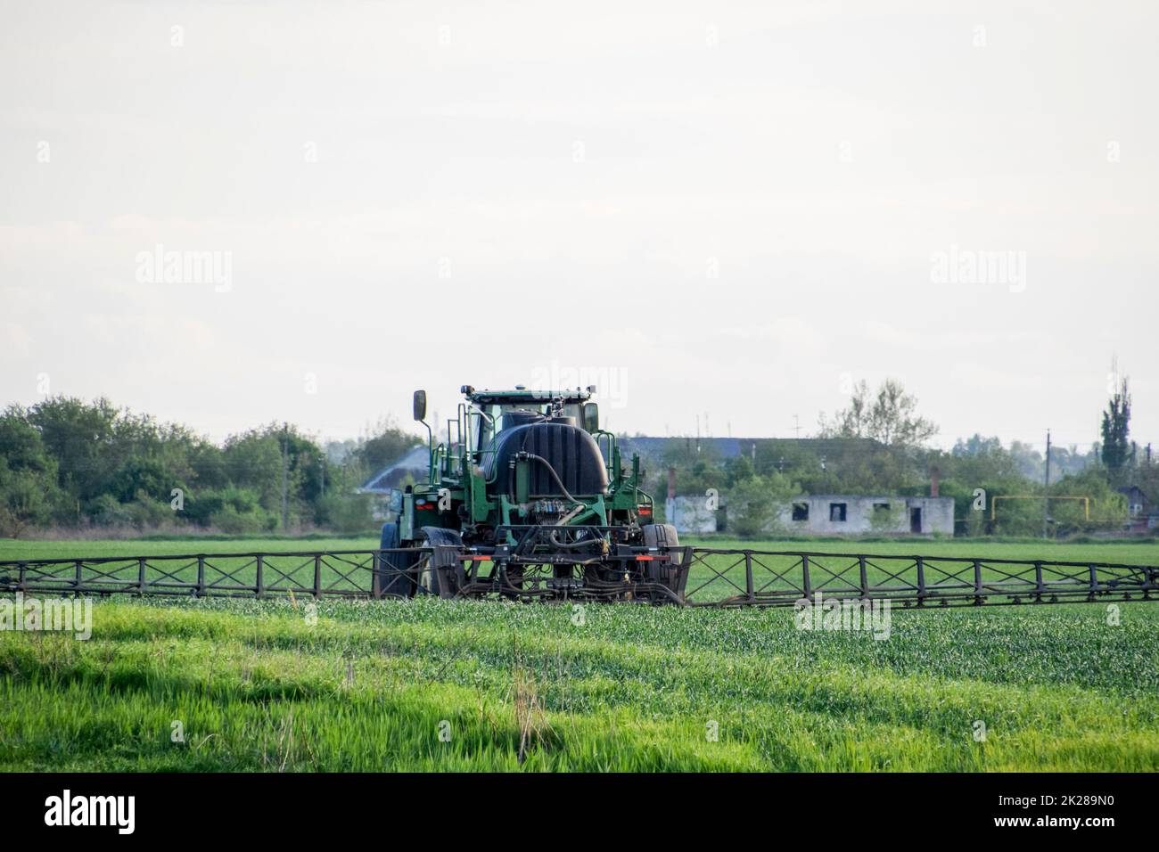 Tractor with a spray device for finely dispersed fertilizer. Tractor on ...