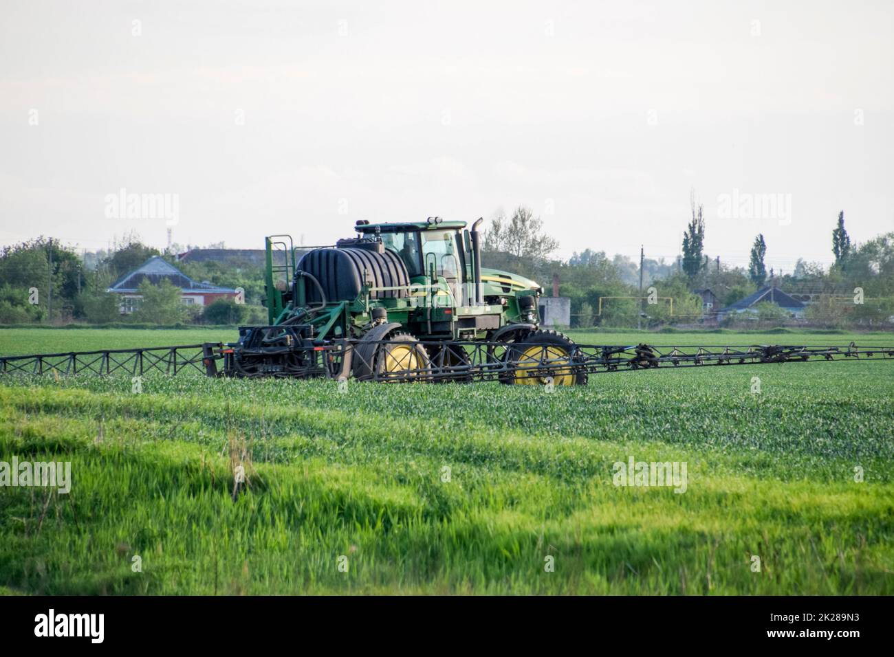 Tractor with a spray device for finely dispersed fertilizer. Tractor on ...
