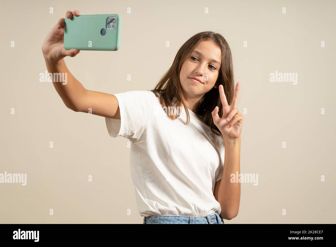 Close-up portrait of a cheerful spanish girl teenager schoolchild pupil ...