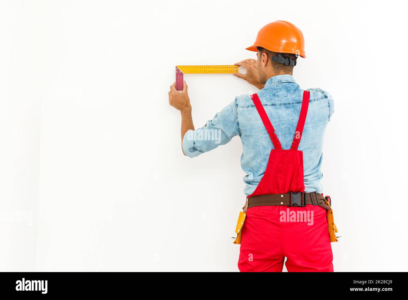 Construction worker pulling a rope. Full length studio shot isolated on ...