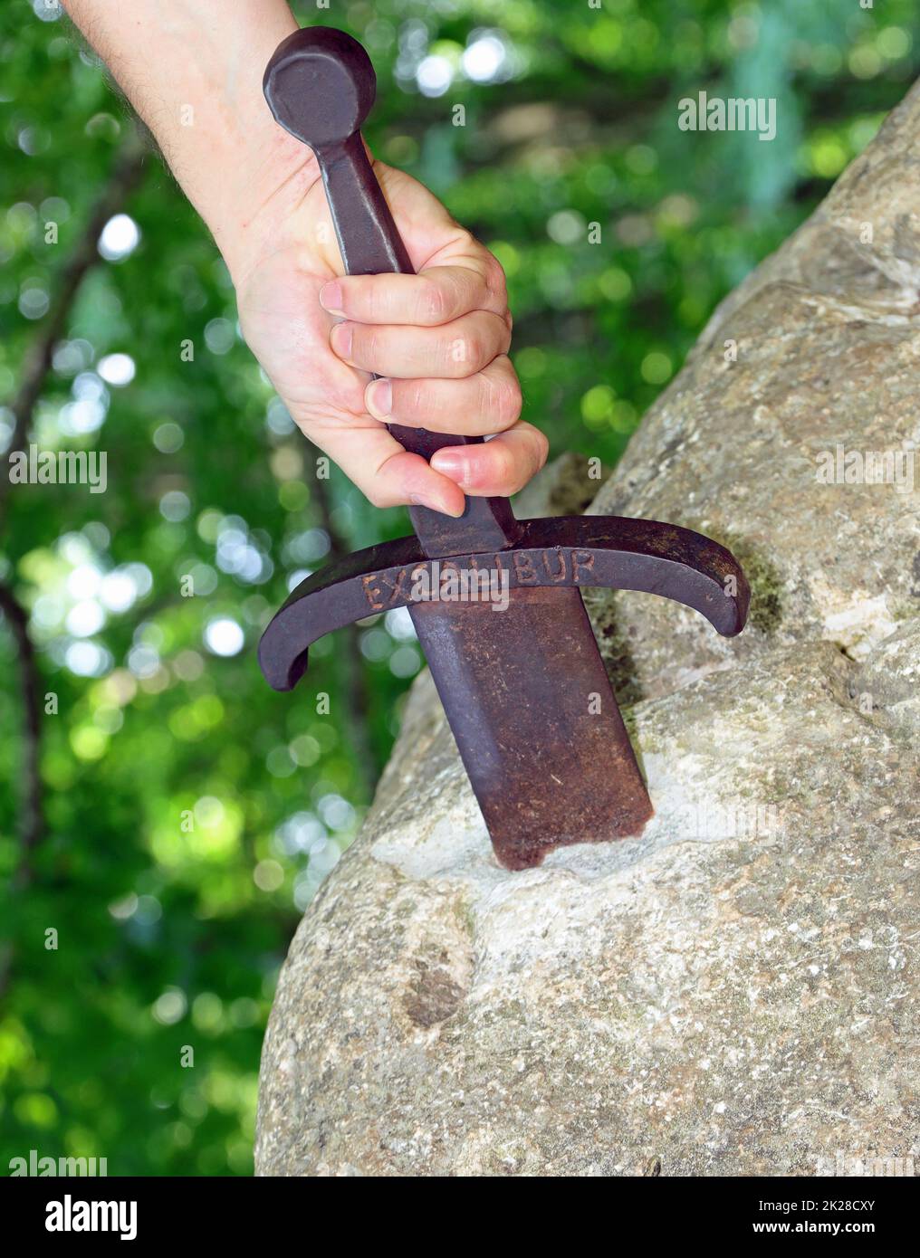 hand of the knight who tries to extract the Excalibur Sword embedded in ...