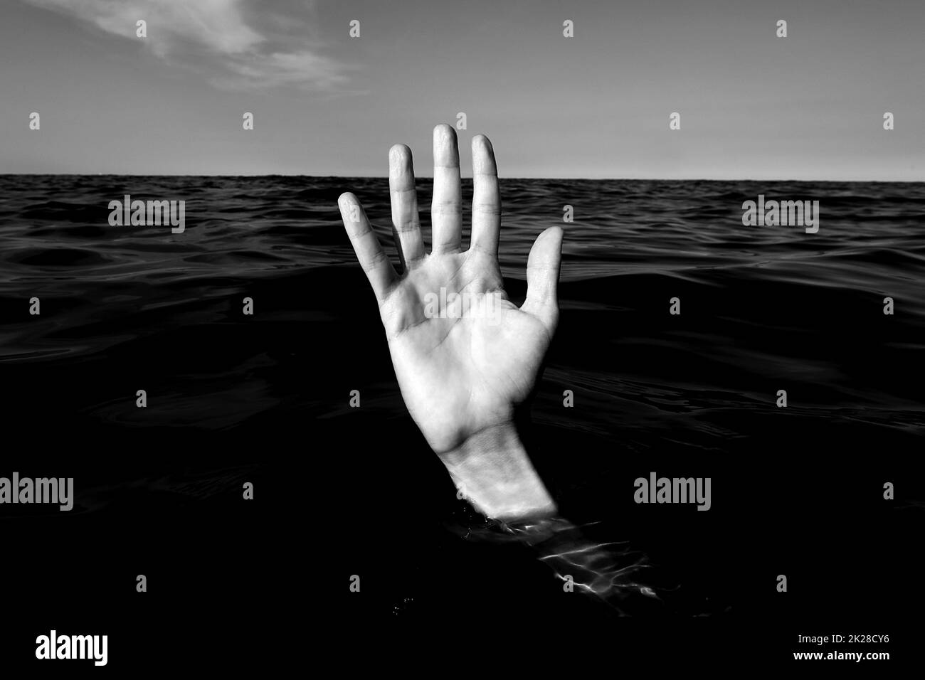 hand IN THE sea of a person who is drowning and seeks help with balck ...