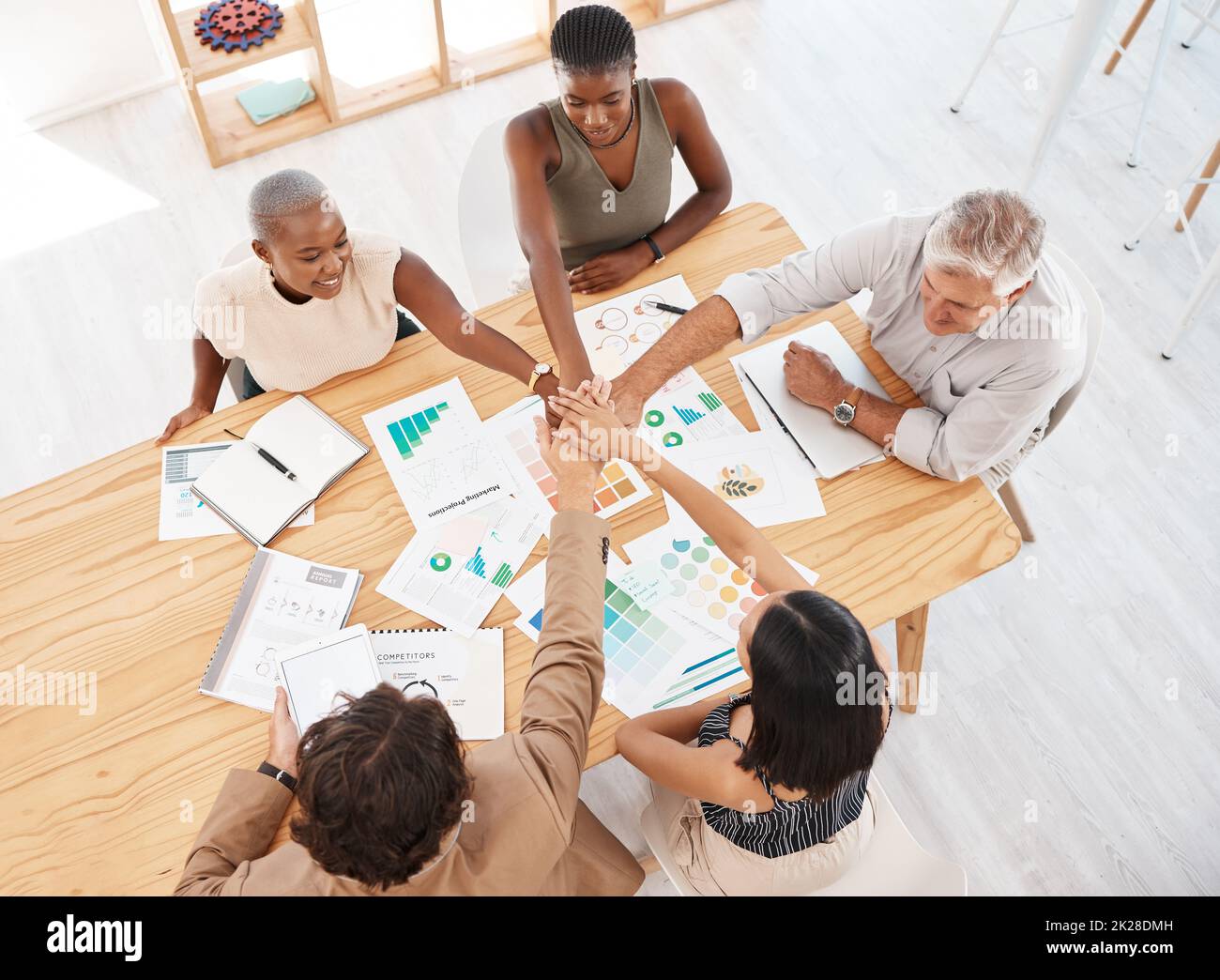 Teamwork, meeting and hands together after a branding and logo group discussion at a business ...