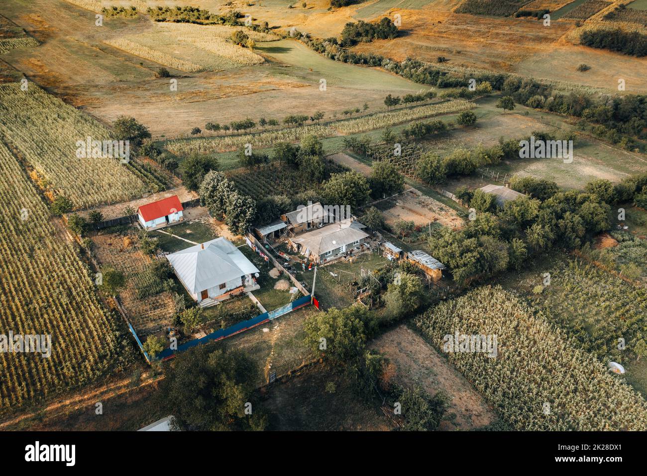 Aerial view of country houses lush pastures & farmlands of Europe ...