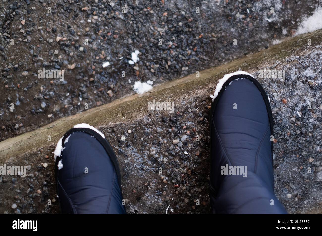 Standing on icy stairs with granite rubble Stock Photo - Alamy