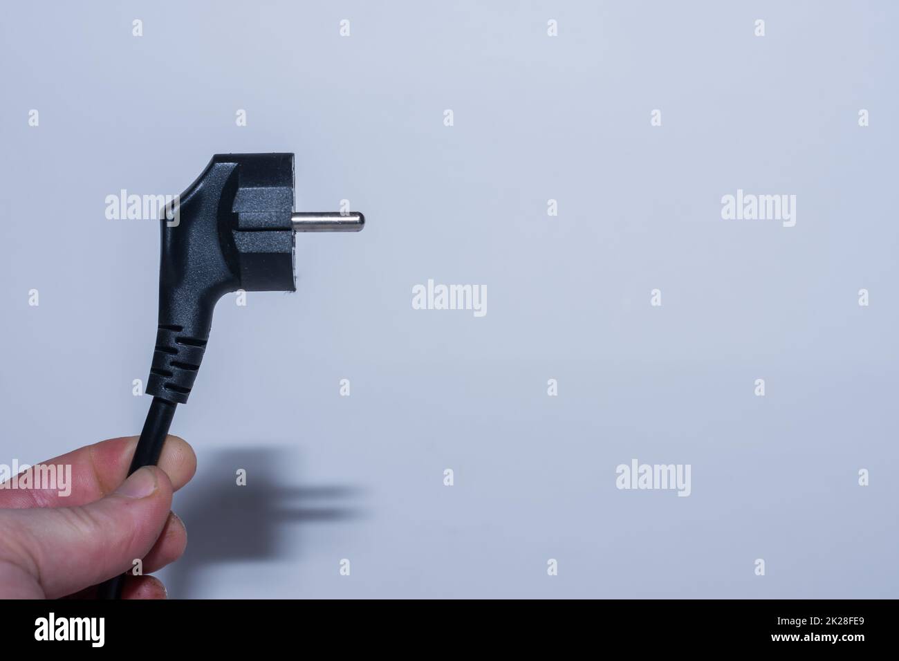 plug held in one hand save electricity left view with gray Stock Photo ...