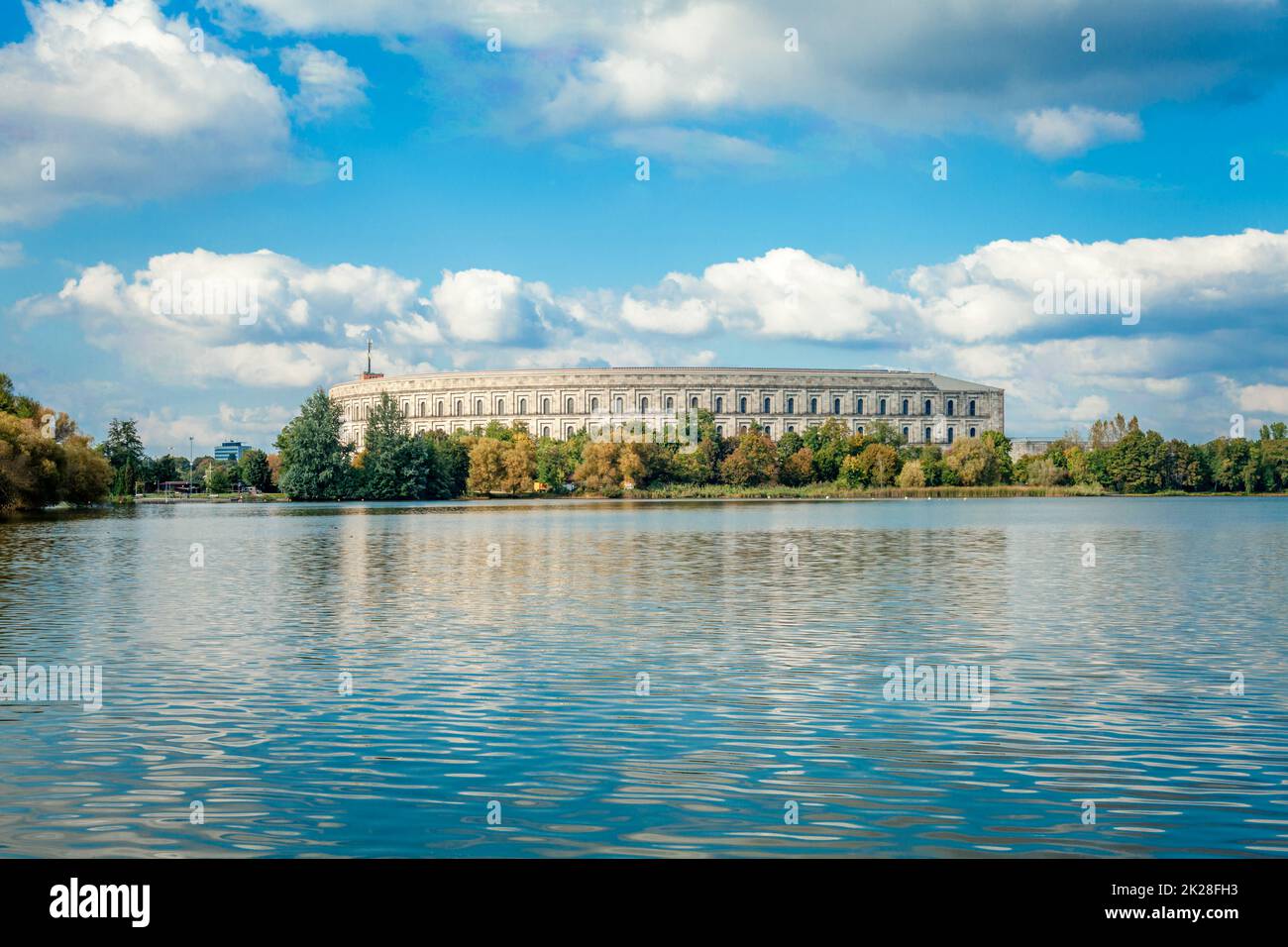 Congress Hall in Nuremberg, view from the lake. water surface and blue ...