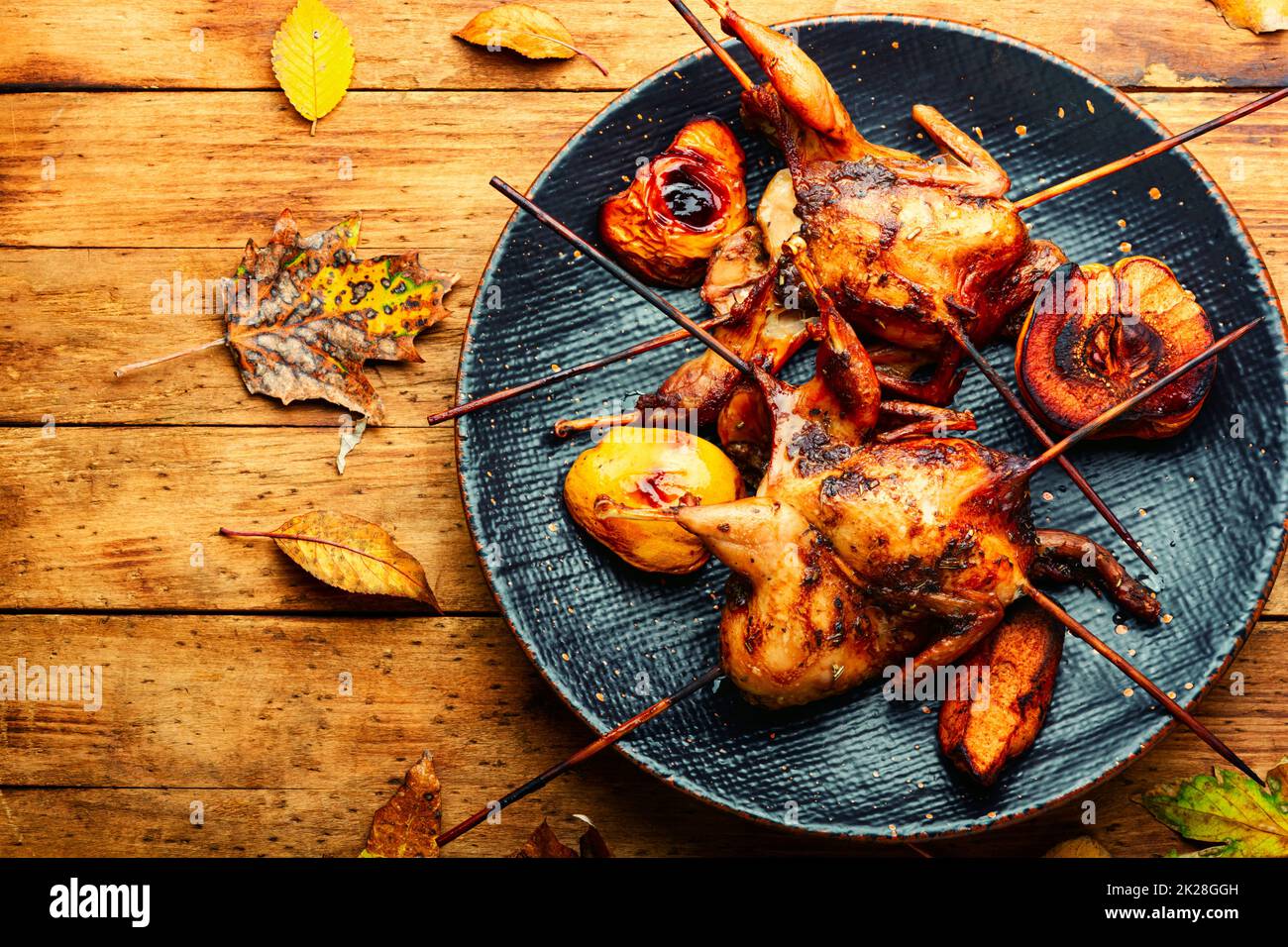 Quail barbecue with quince Stock Photo - Alamy