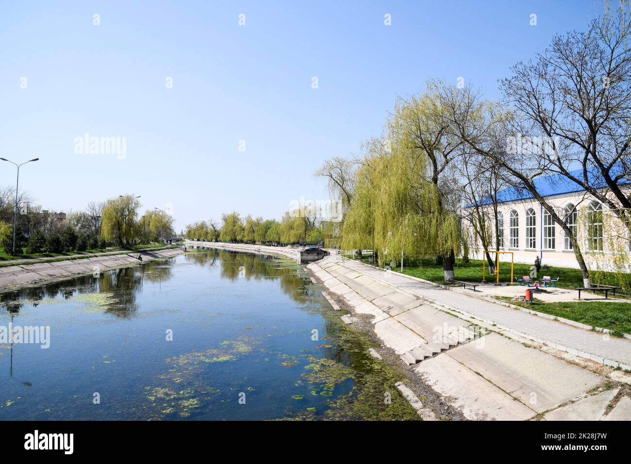 River in the village. Concrete slabs lined riverside in the city Stock ...