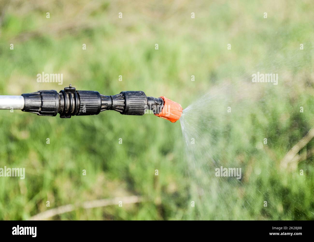 Spraying herbicide from the nozzle of the sprayer manual Stock Photo ...