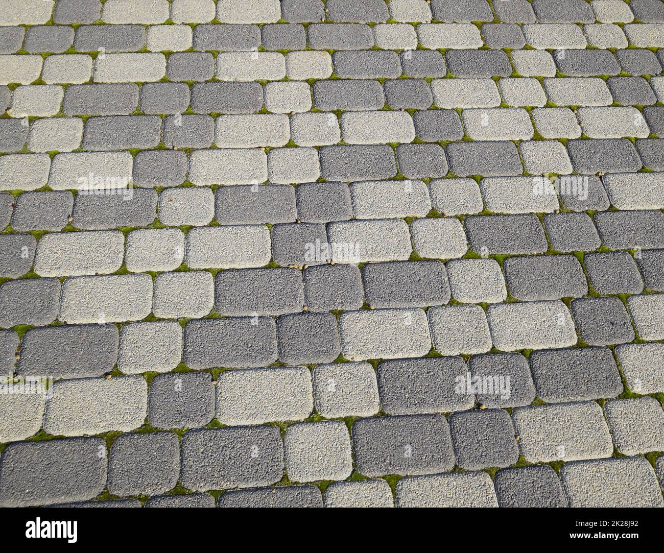Industrial building background of paving slabs with overgrown with moss ...