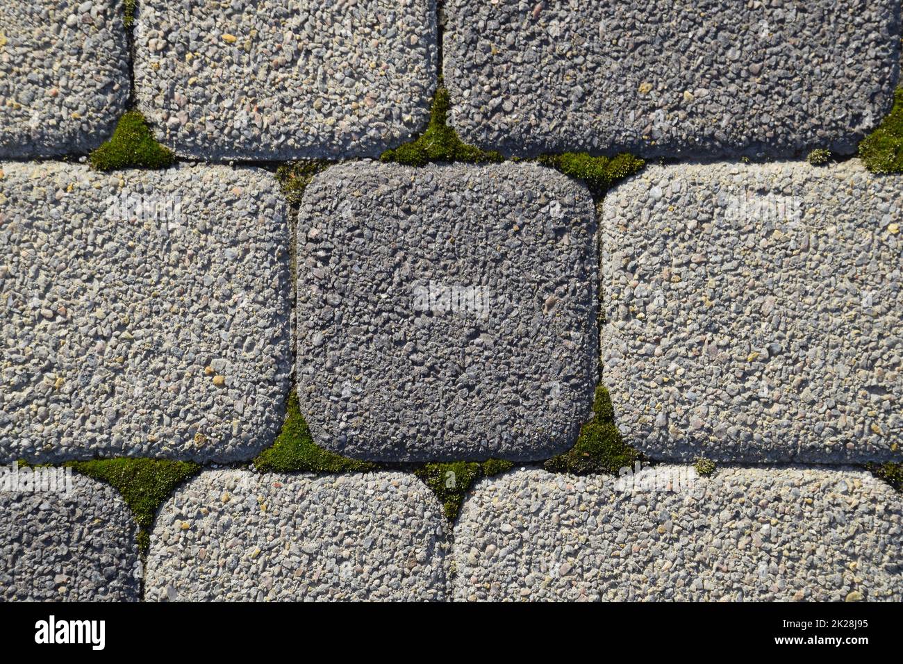Industrial building background of paving slabs with overgrown with moss ...