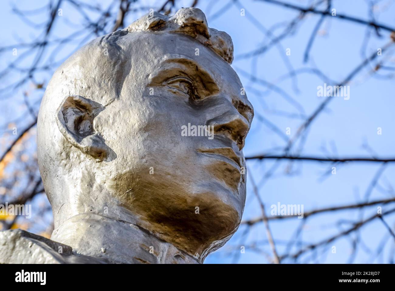 The face of the stone man. Concrete soldier bust covered with pa Stock ...
