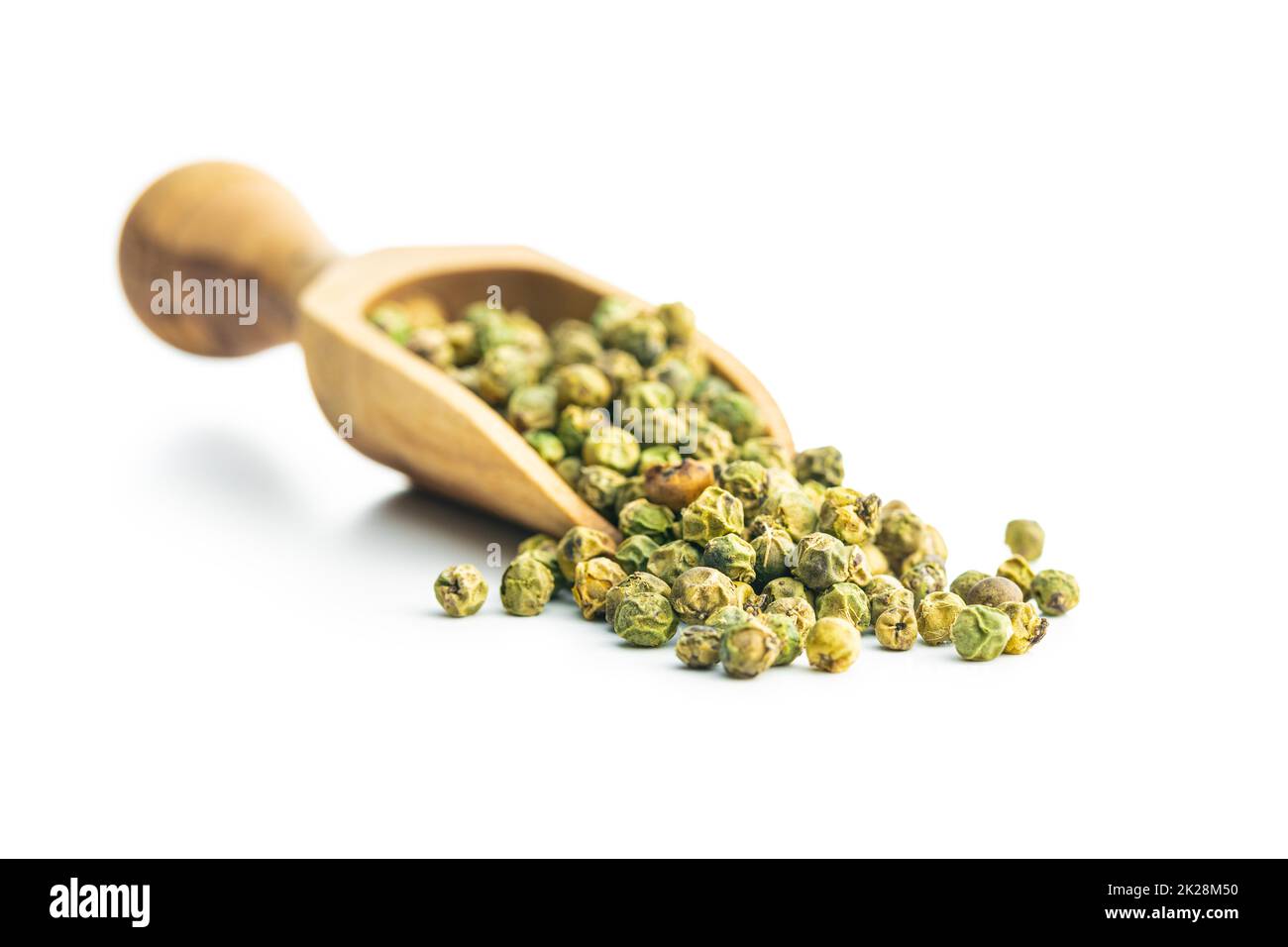 Dried green peppercorn. Dry green pepper spice in scoop isolated on ...