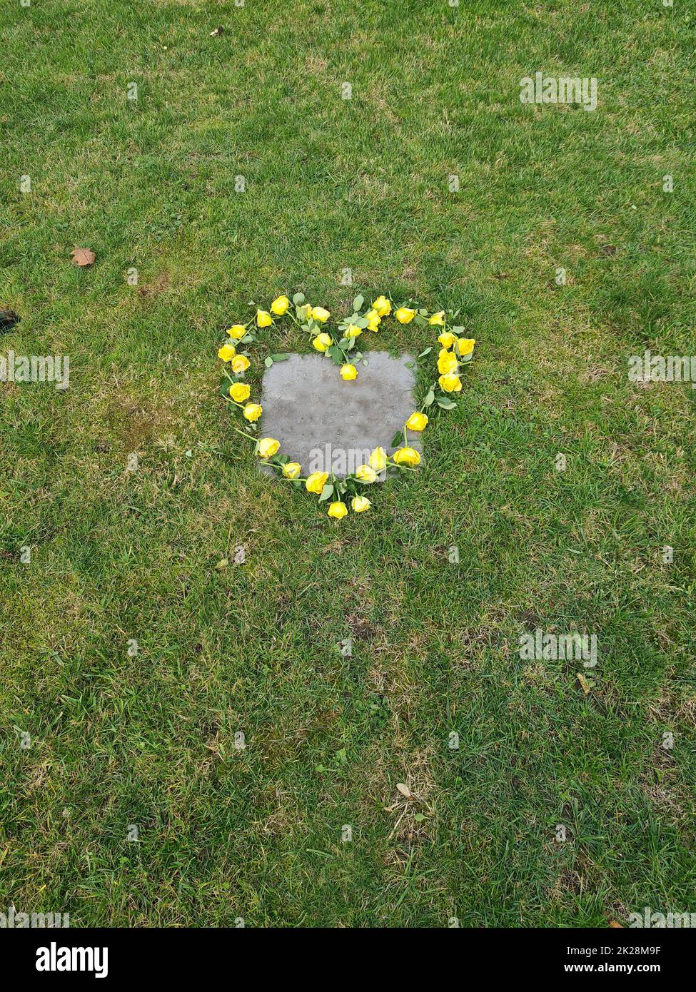 Grave slab with a flower heart Stock Photo - Alamy