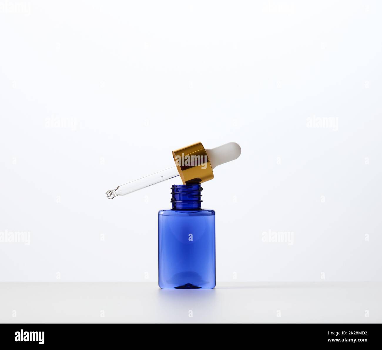 blue glass bottle with a pipette on a white background. Template for ...
