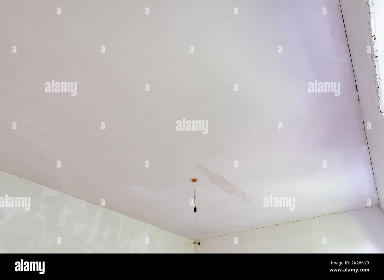 Plastered ceiling in the room, stains from flooding from above are ...