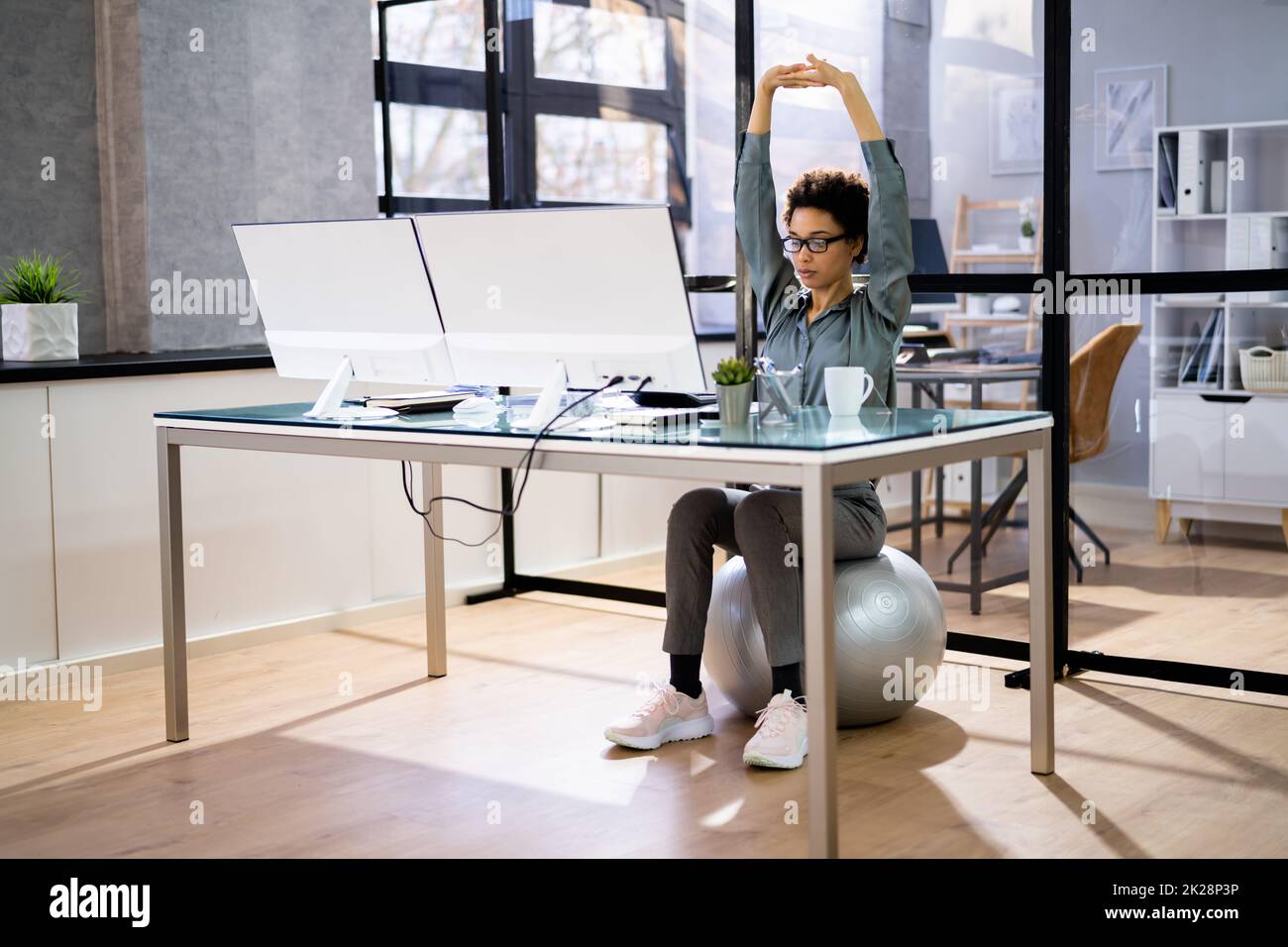 Female office using exercise ball hi-res stock photography and images ...
