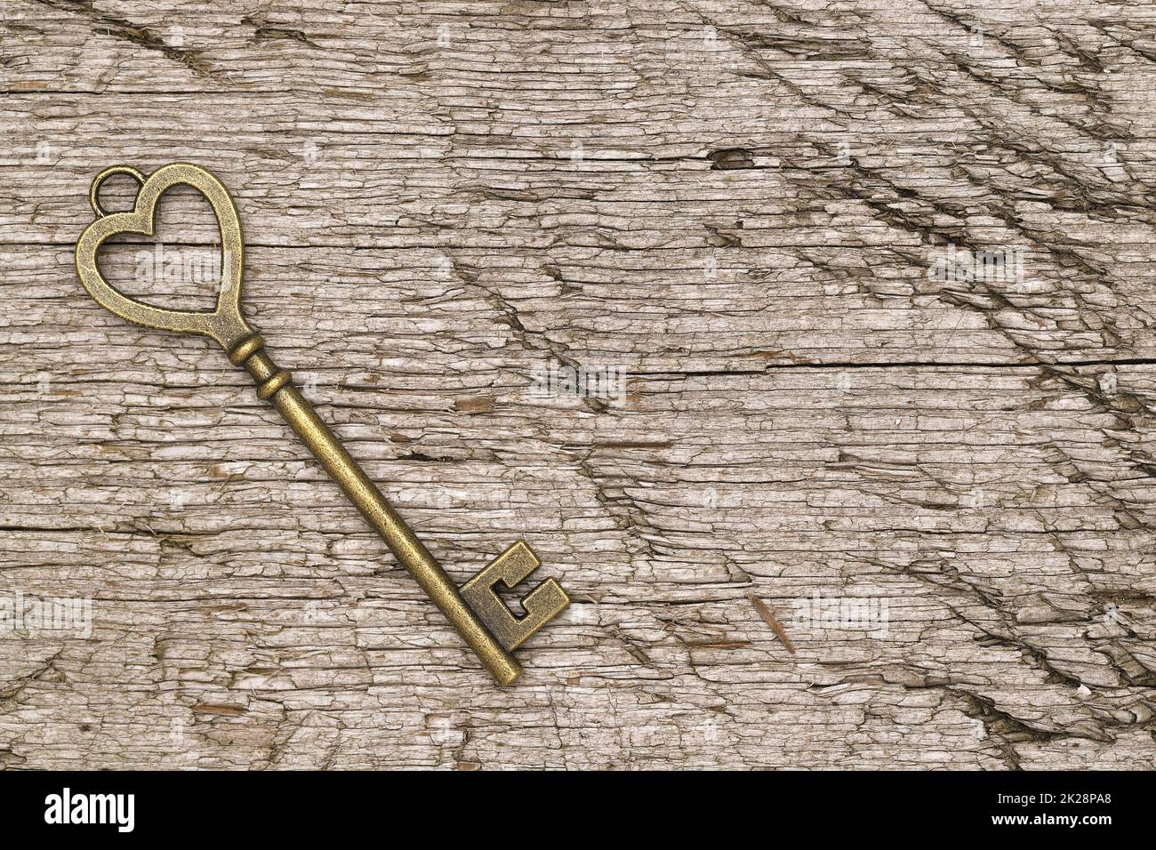 heart shaped vintage key on a grungy wooden background Stock Photo - Alamy