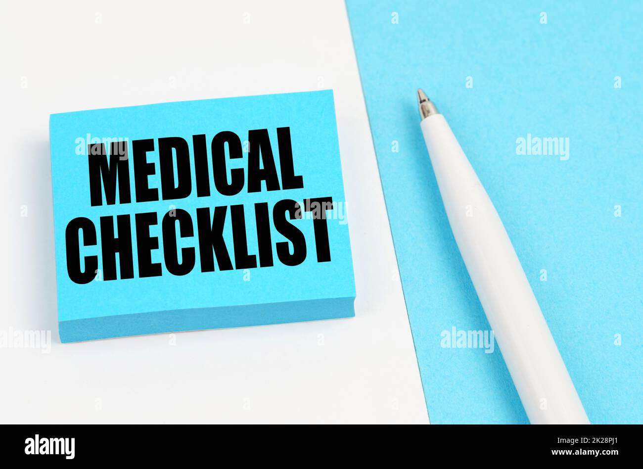 Medical concept. On a white and blue surface, a pen and blue stickers ...