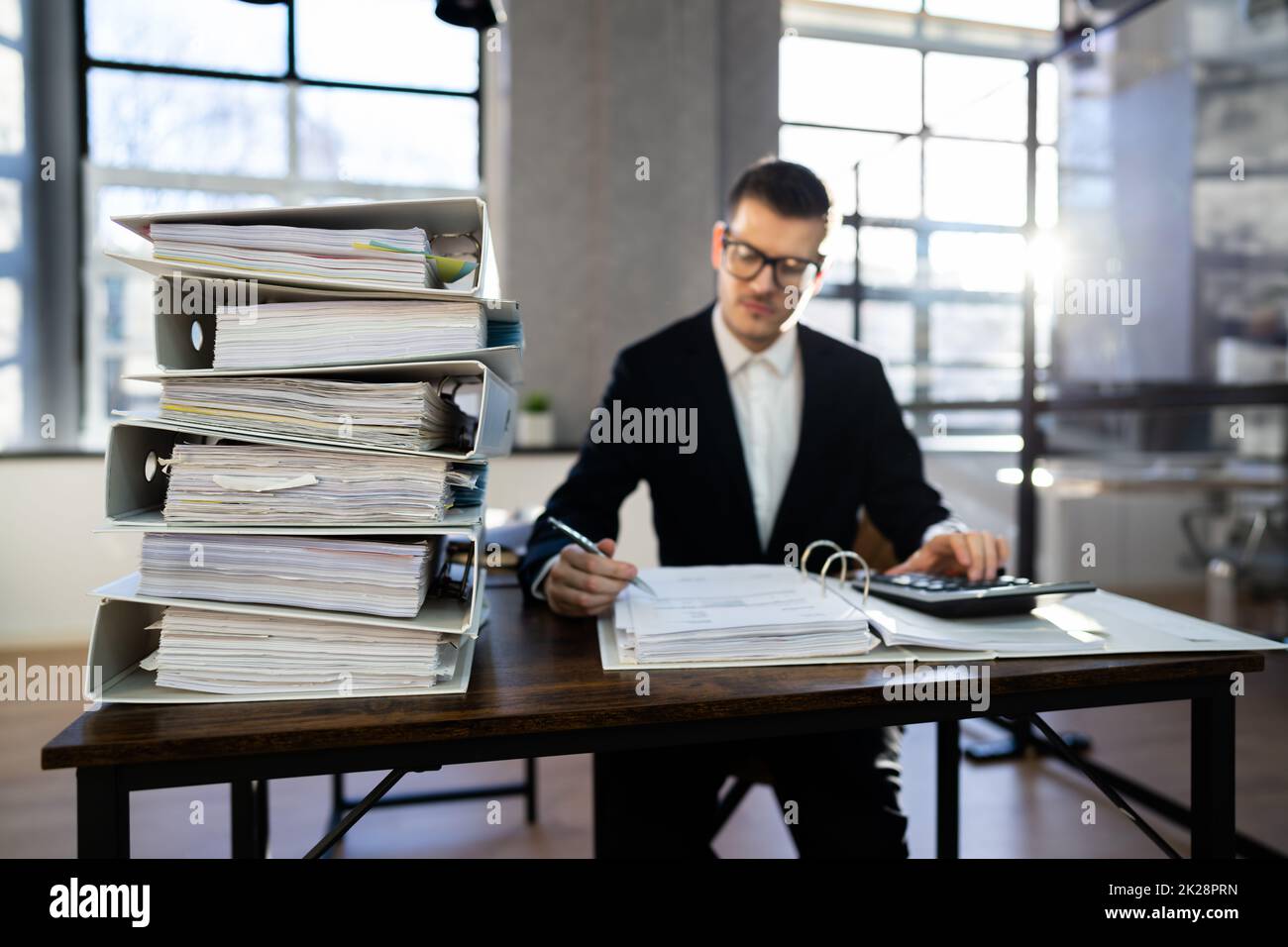 Accountant With Folders Paper Stack Doing Invoice Stock Photo - Alamy