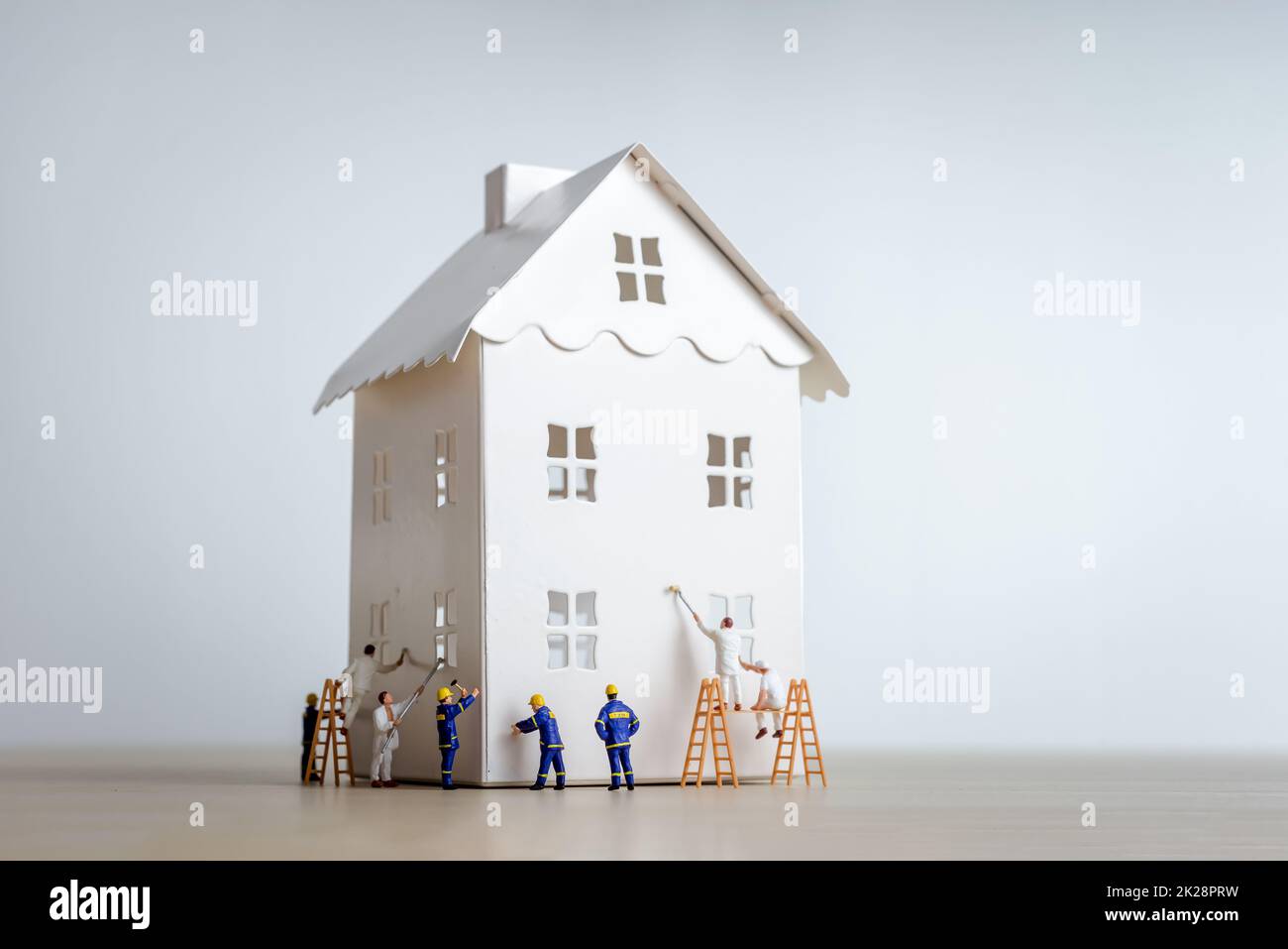 Figurines of builders and painters working on a house Stock Photo - Alamy