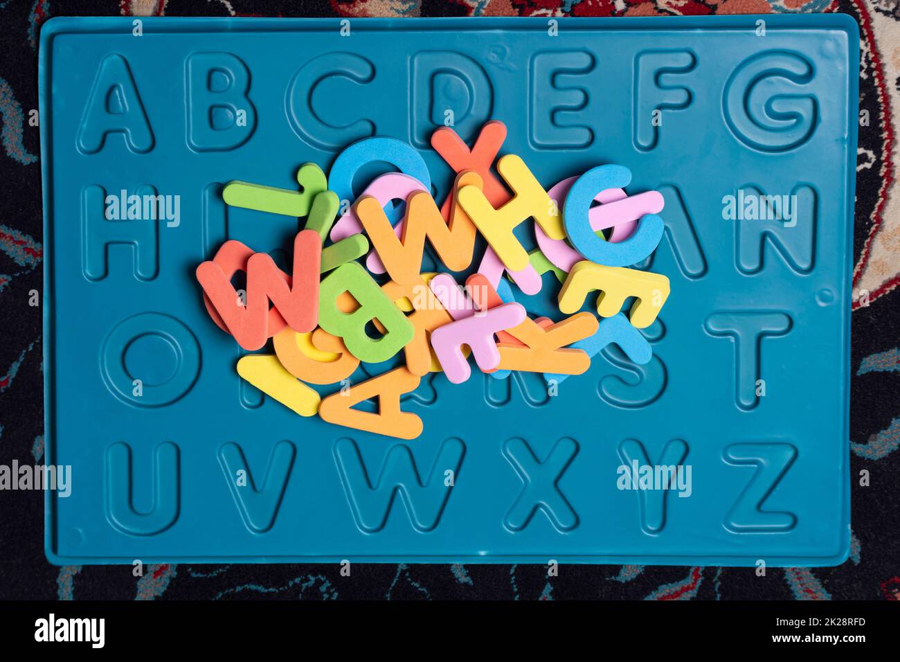 Kids educational colorful spongy letters on carpet Stock Photo - Alamy