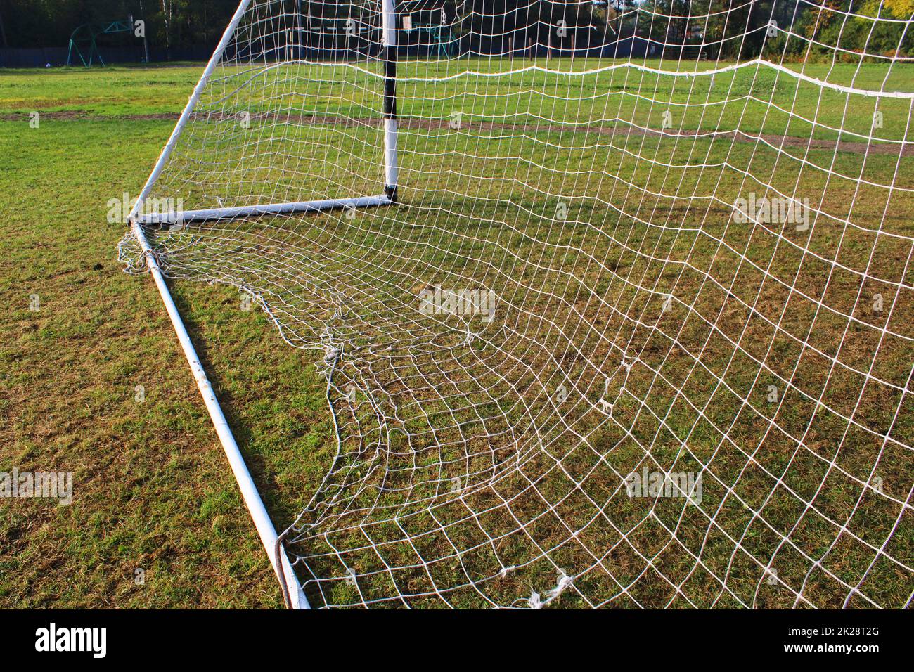 Old football goal against the background of the football field and ...