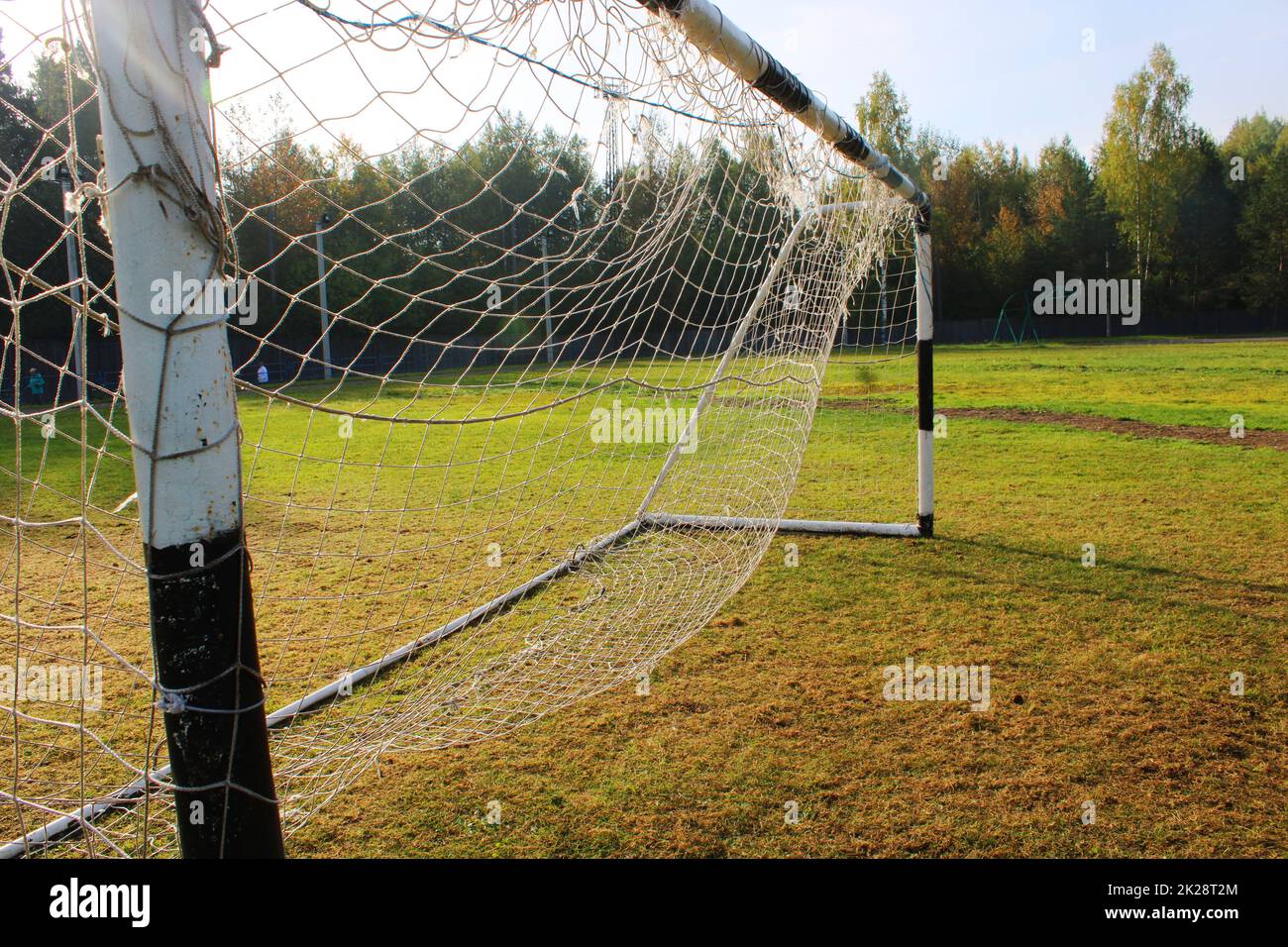Old football goal against the background of the football field and ...