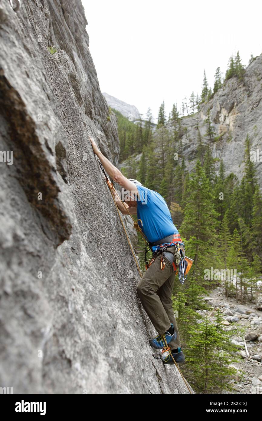 Man climbing rock face hi-res stock photography and images - Alamy