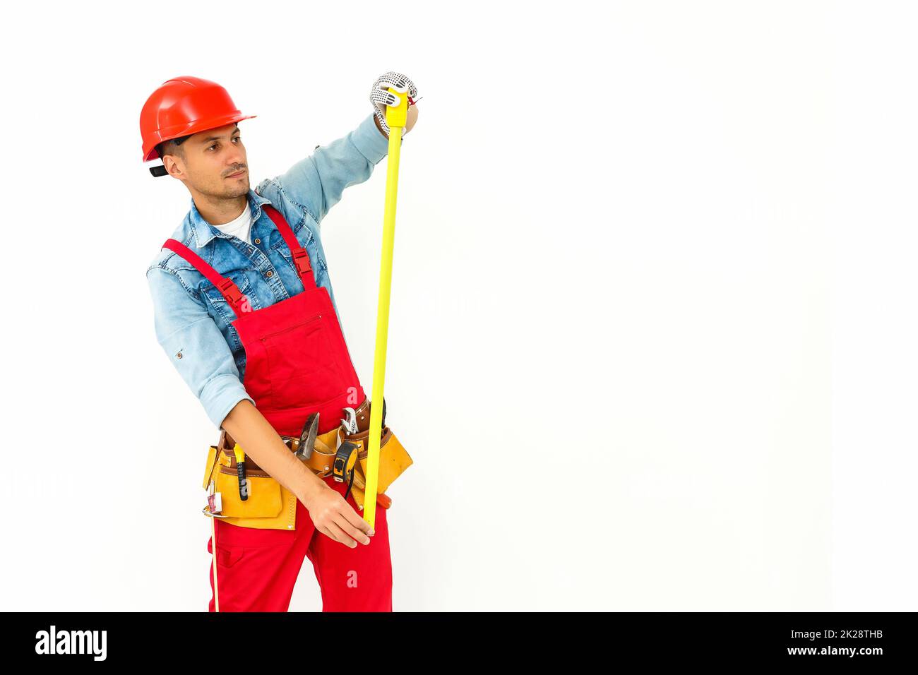 Construction worker pulling a rope. Full length studio shot isolated on ...