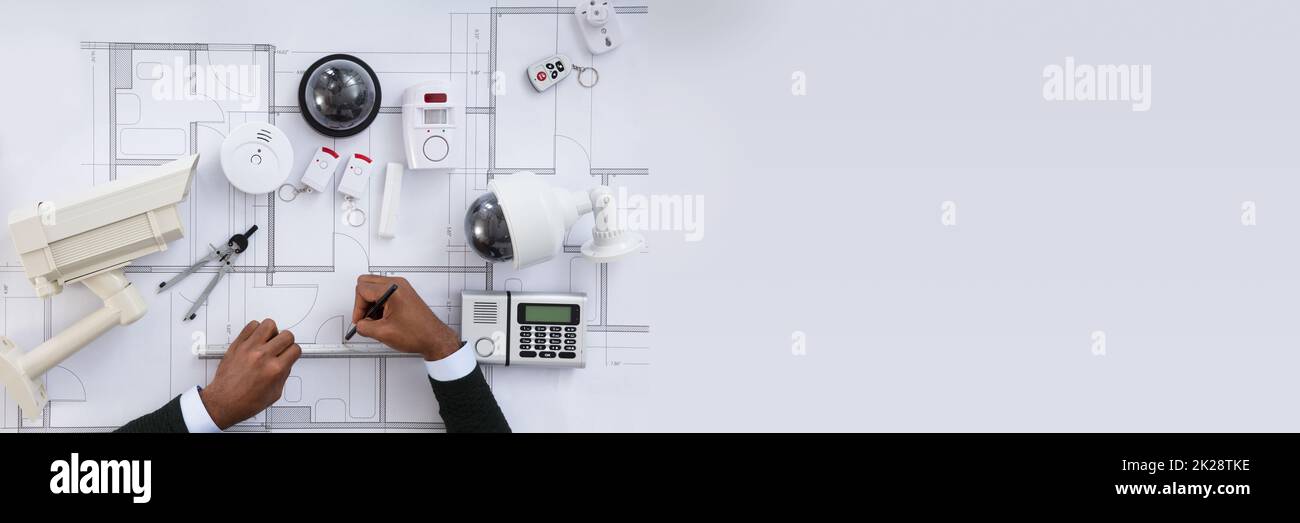 African Security Engineer Working On Home Alarm Blueprint Stock Photo ...
