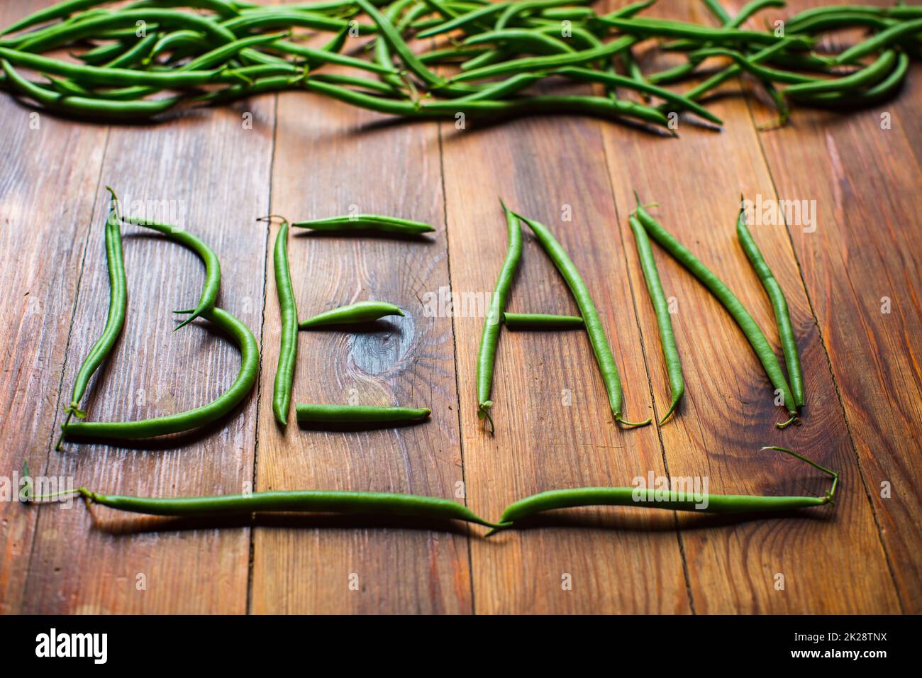 The word beans made from pods on a wooden table. Plantation work ...