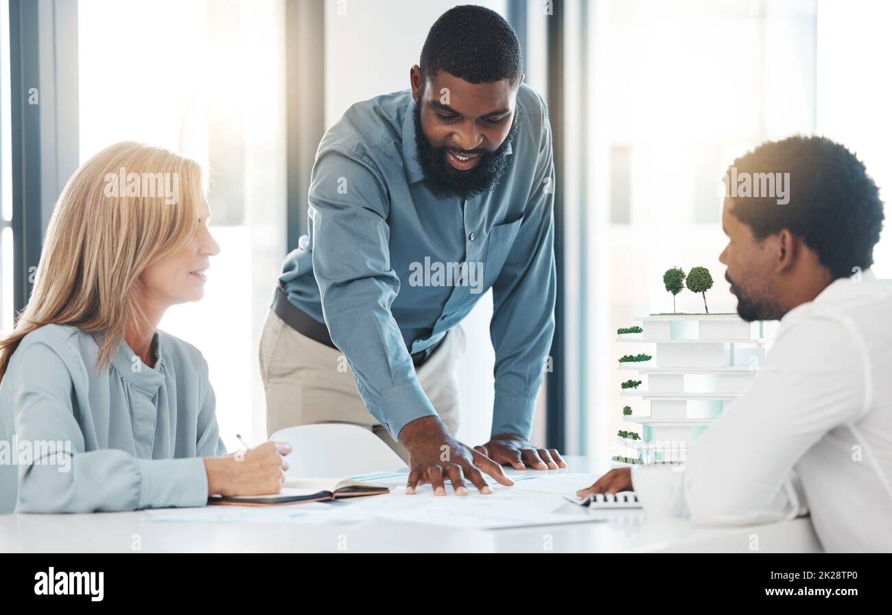 Teamwork, planning and coaching with a business man talking to his team ...