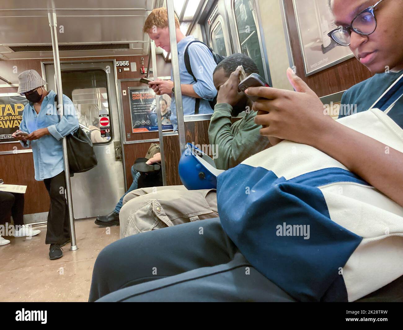 Masked and mask-less on the subway terminal in New York on Wednesday ...