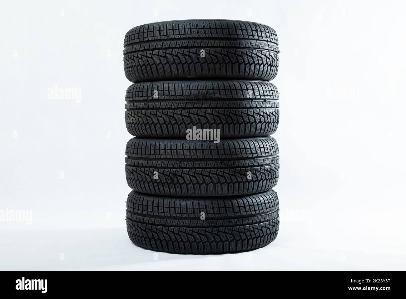 Stack of winter tires with specific structure and deep ridges shot in ...