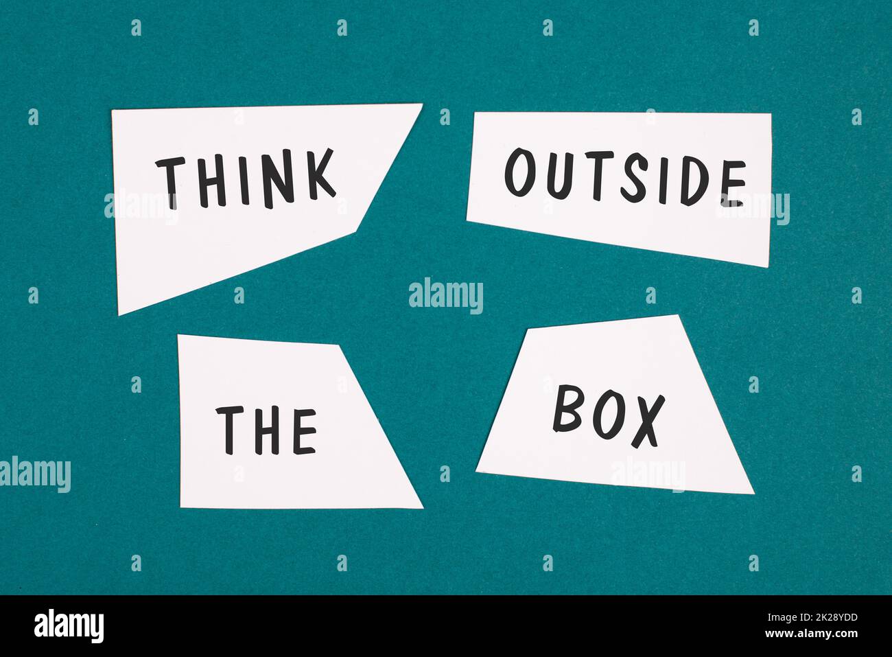 Think outside the box is standing on pieces of white paper, petrol ...
