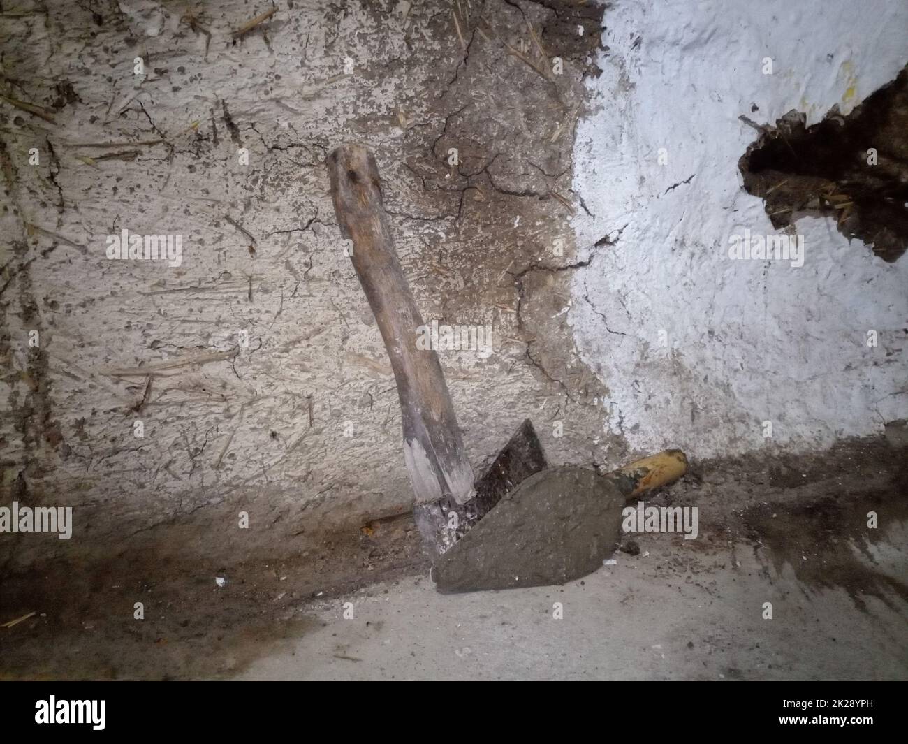 Renovation in room with clay plaster. Peeling plaster from the wall ...