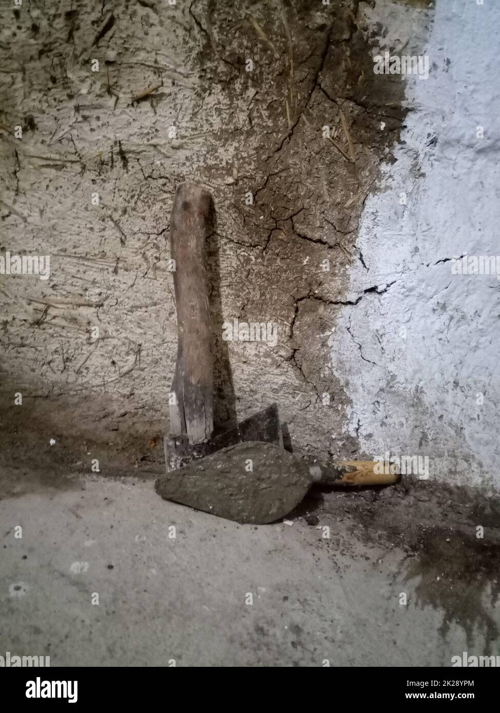 Renovation in room with clay plaster. Peeling plaster from the wall ...