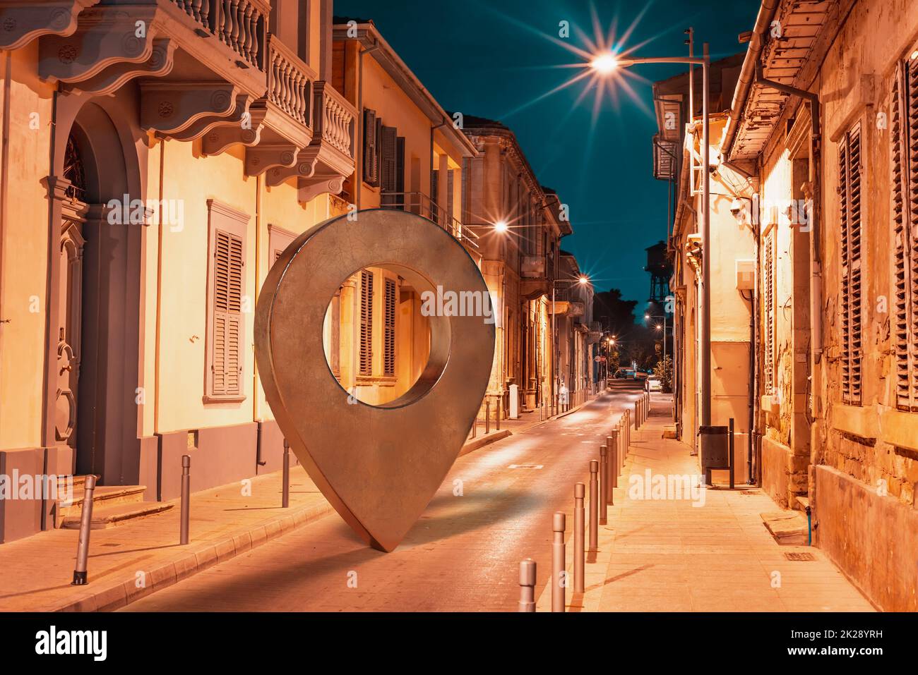 Street at Limassol old town with giant location pin Stock Photo - Alamy