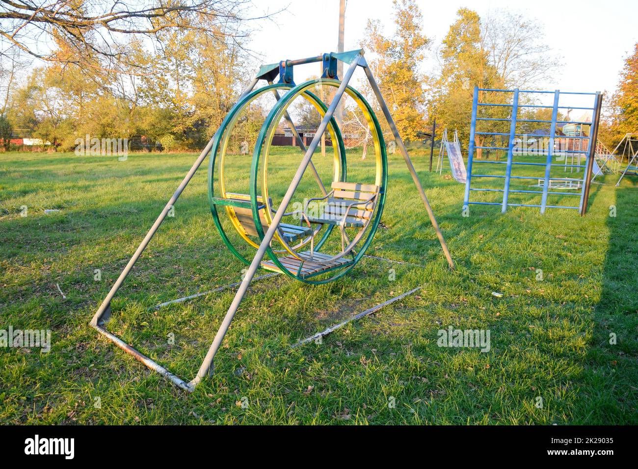 Swing on the playground. Children playground. Swings and a slide to ...