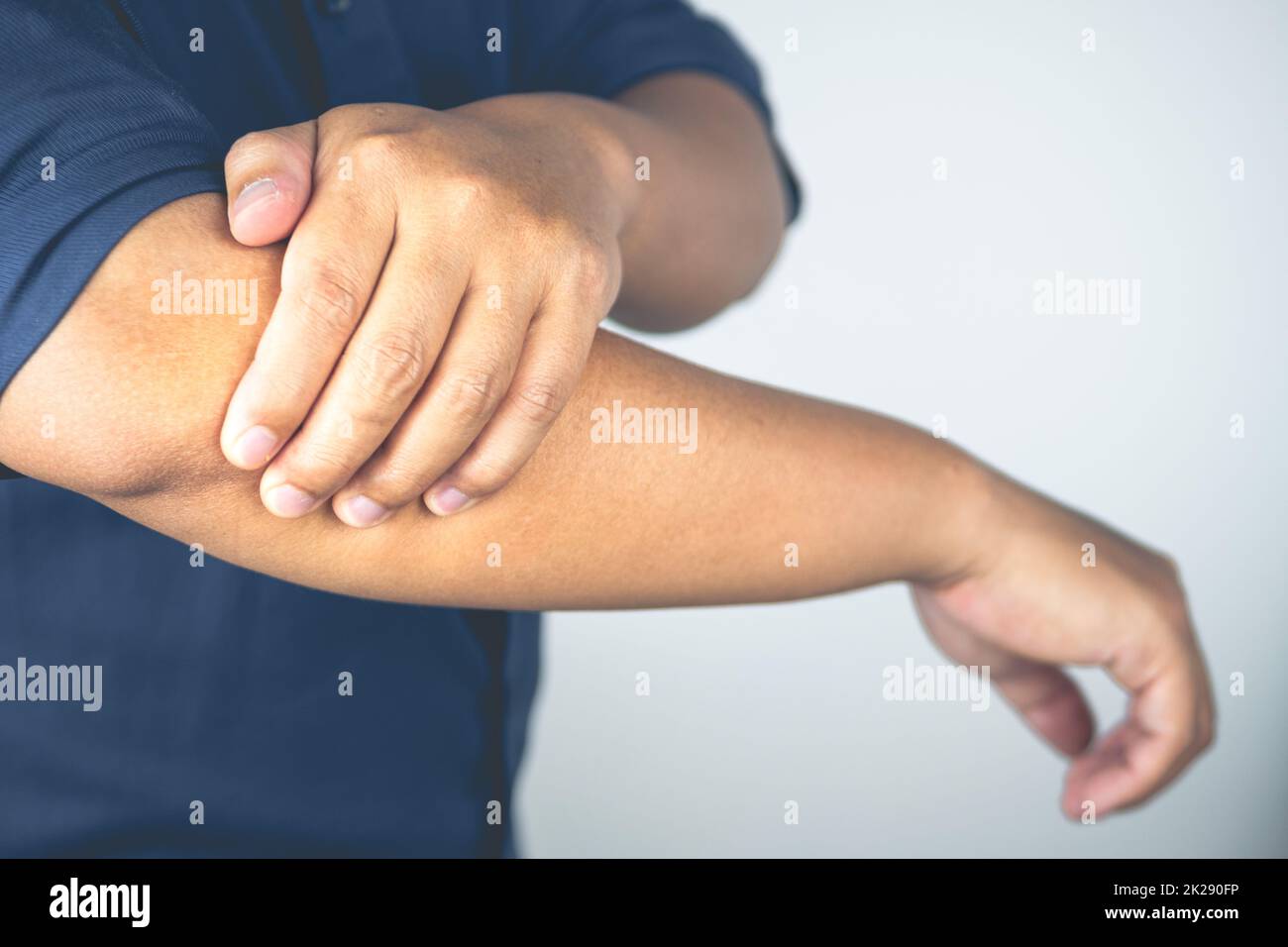 The man pains elbow. These symptoms may cause by sport, hard work with ...