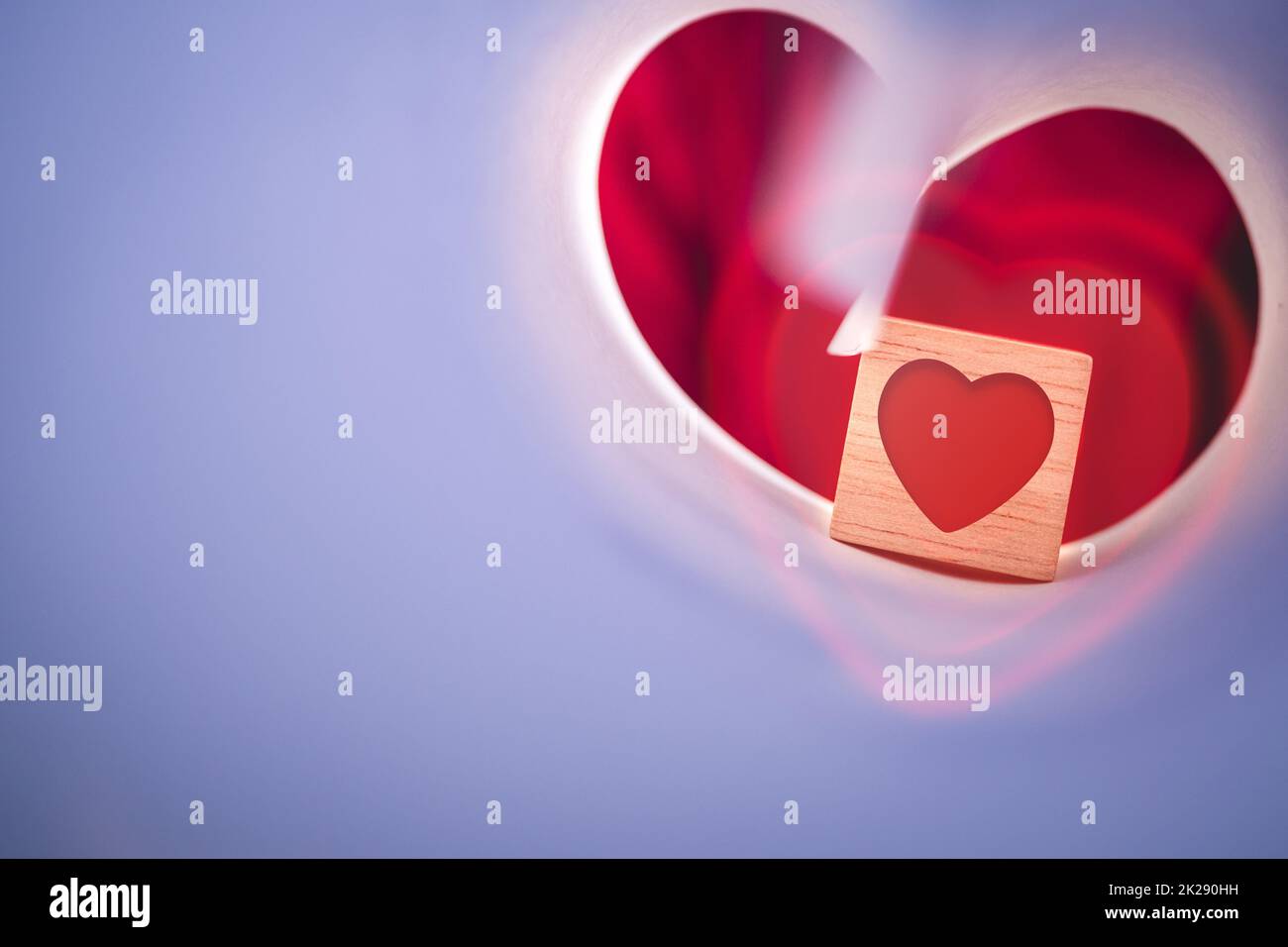 Valentine's day concept. Wood block with Heart in white paper roll ...