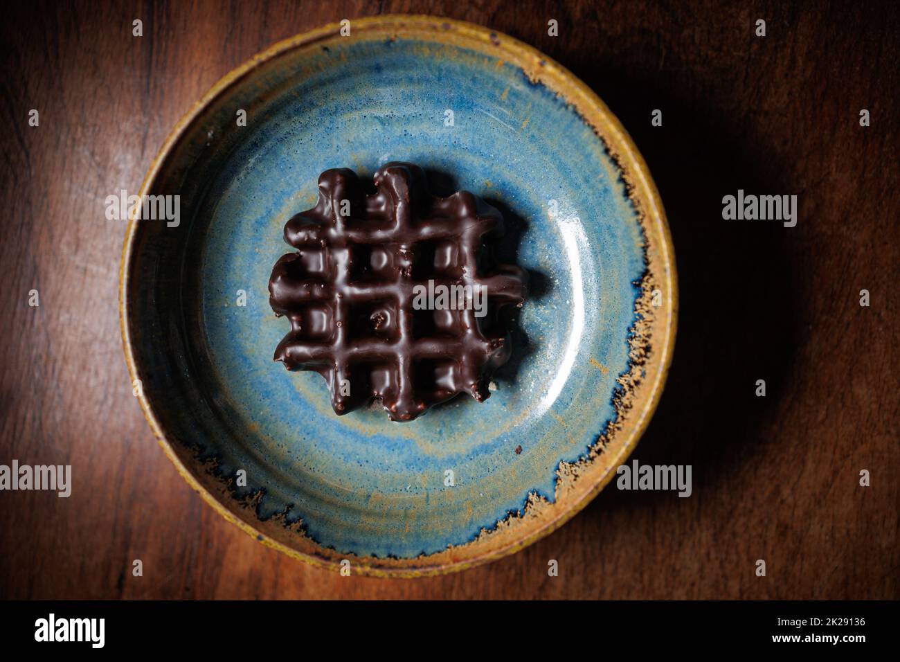 Chocolate waffle in handmade clay plate Stock Photo - Alamy