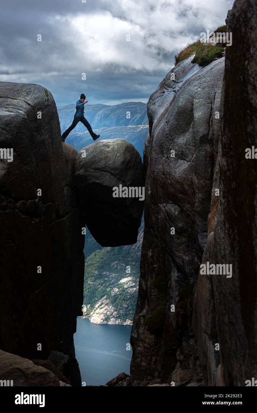 Tourist jumps on giant boulder, Visiting Norway Kjeragbolten located ...