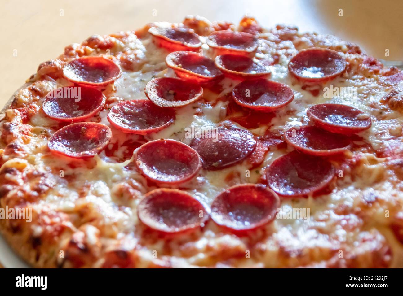 Delicious salami pizza in close-up macro view with cheese and tomato ...