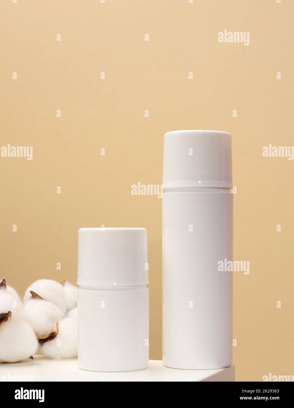 empty white plastic bottle on a beige background. Cosmetic products for ...