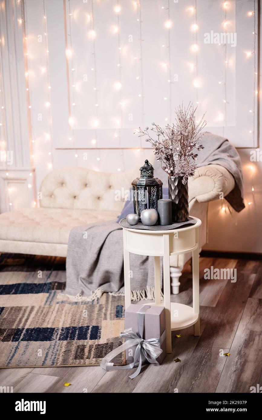 Decorative antique silver retro lamp on a white small table in the ...