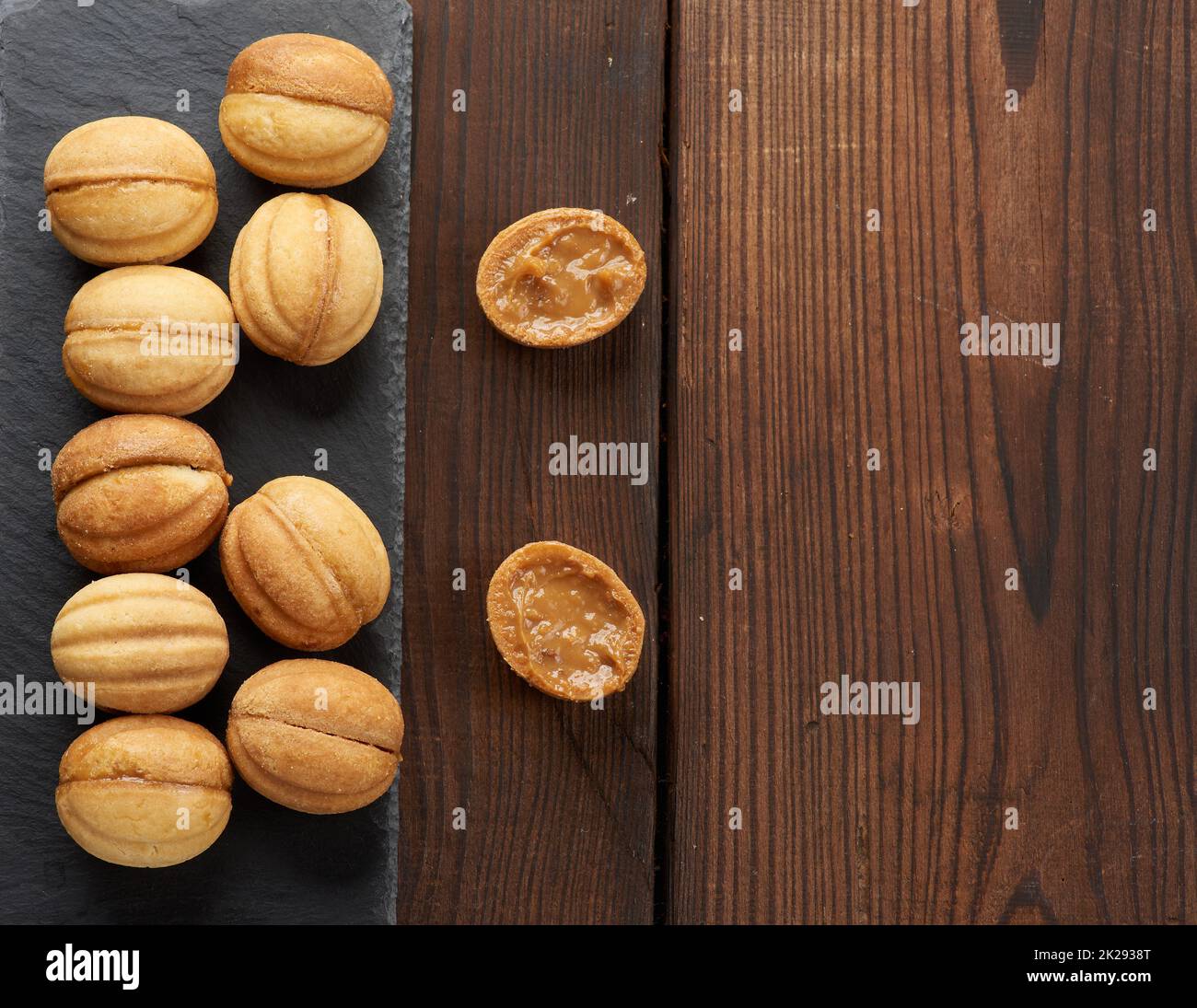 baked dessert nuts with condensed milk on black slate board, top view ...